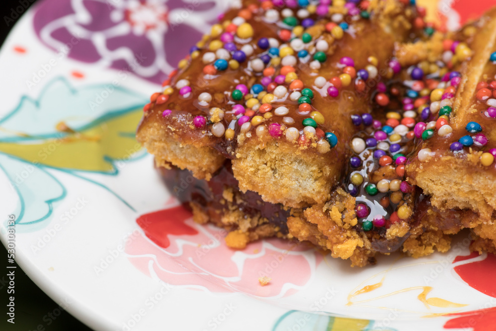 Girl eating Turron dona pepa dough with honey traditional peruvian ...