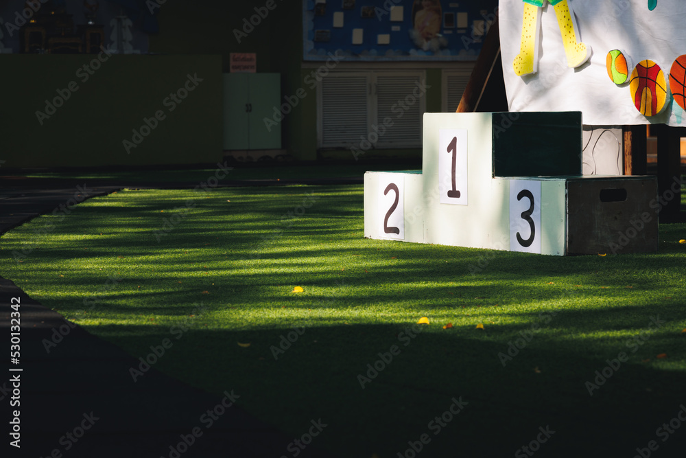 Sport stage podium for champion winner in green grass field. Sport ...