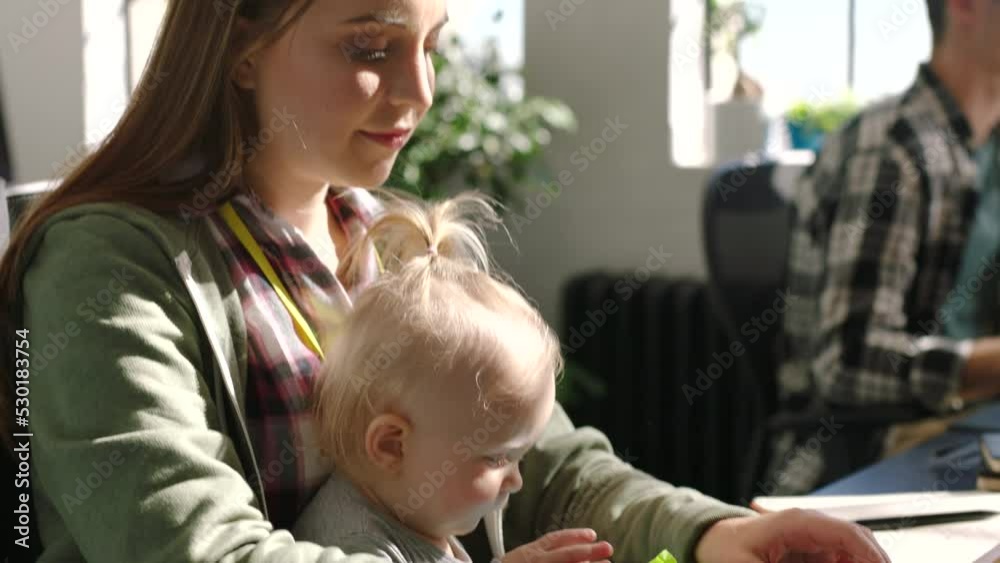 Office business woman, mother with baby and working typing at computer ...
