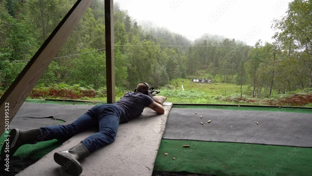Person with hunting rifle shooting at targets on shooting range - Shots ...