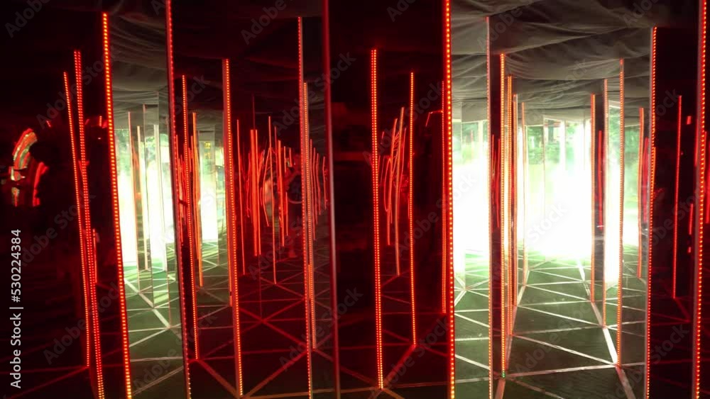 Mirrors flicker in the maze. Beautiful girl in infinity mirror maze ...