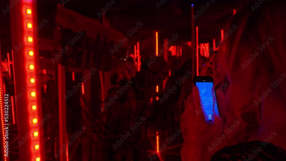 Beautiful girl taking photo witn scary skeleton in mirror maze ...