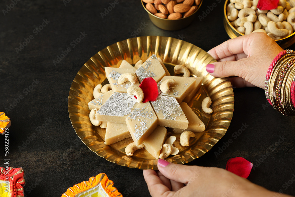 Kaju Katli Kaju Barfi Burfi cashew fudge candy woman hand serving ...