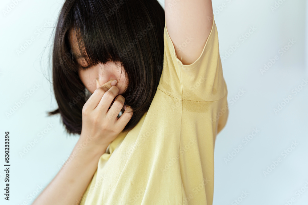 The woman in the yellow shirt covered her nose with her hands because ...