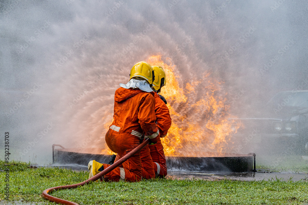 Firefighters wearing helmets with fire safety equipment Use Twirl ...