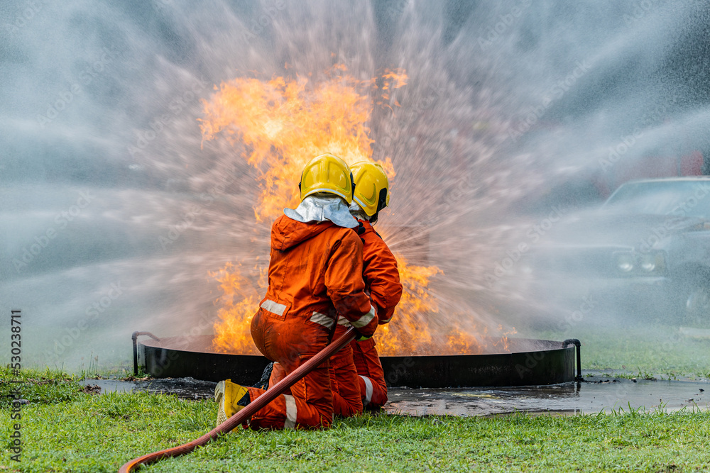Foto de Firefighters wearing helmets with fire safety equipment Use ...
