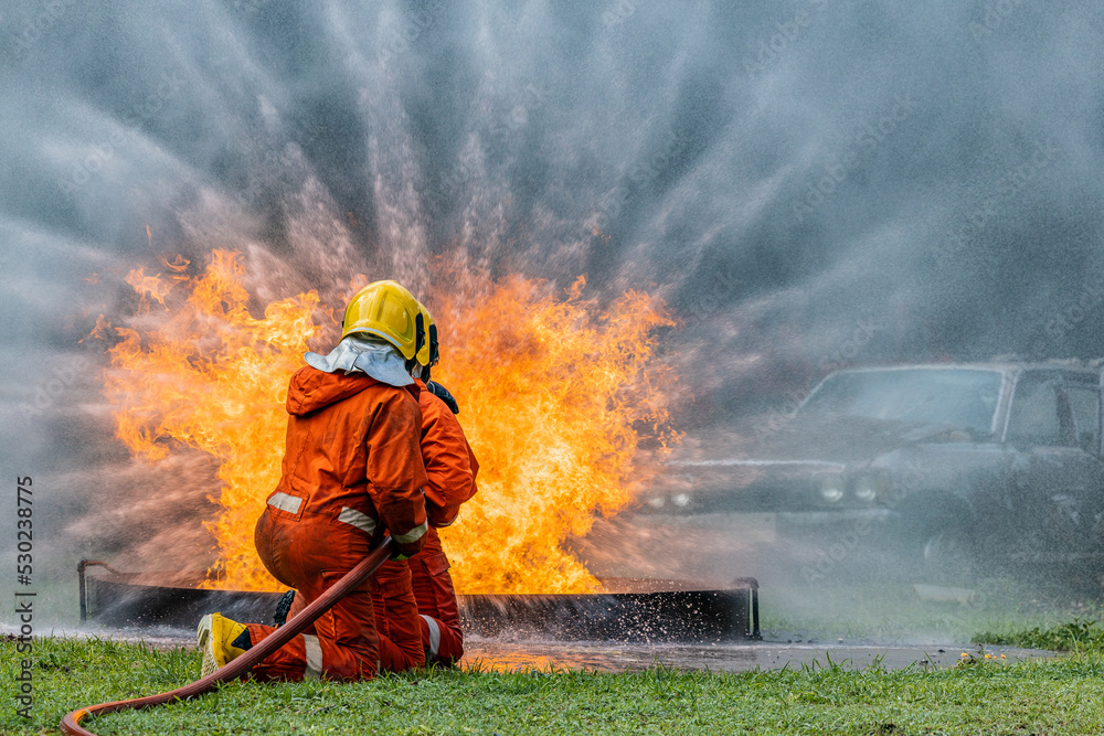 Firefighters wearing helmets with fire safety equipment Use Twirl ...