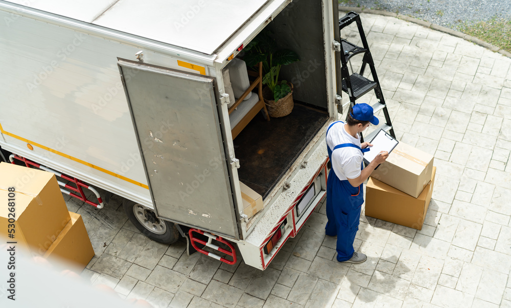 top view of Workers unloading boxes from van outdoors.House move, mover ...