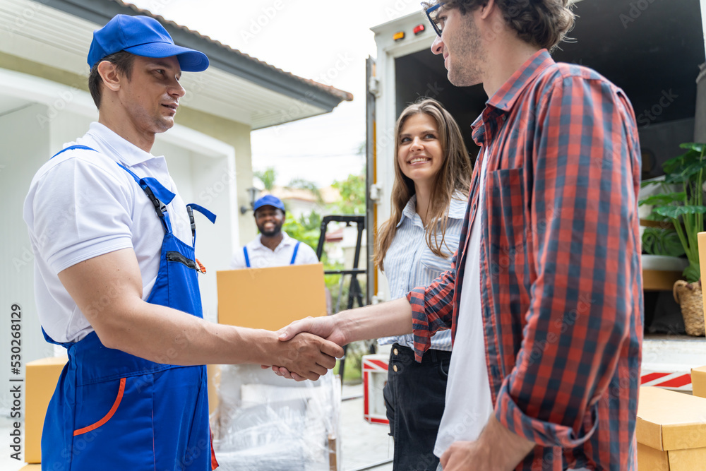 Men mover worker in blue uniform and Homeowner making handshake to work ...