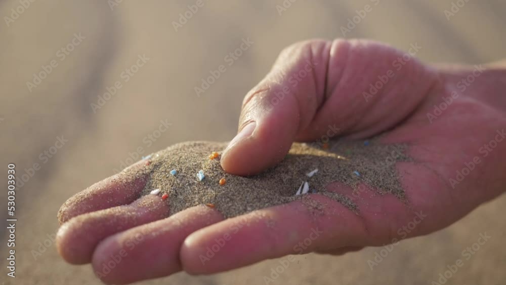 pieces of microplastic on the sand beach. primary and secondary ...