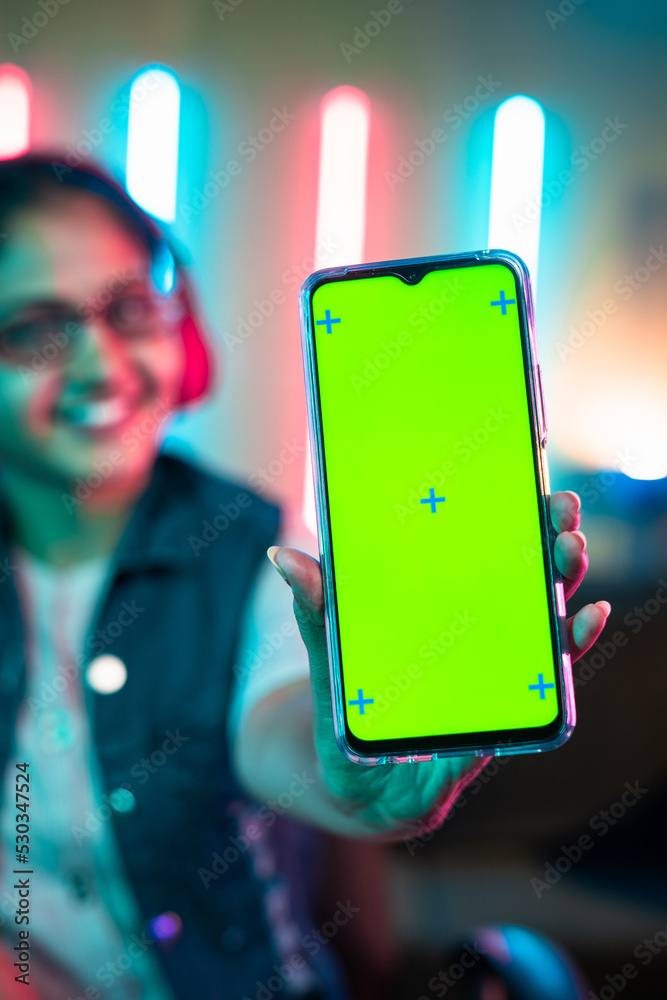 focus on mobile phone, Smiling girl showing green screen mobile phone ...