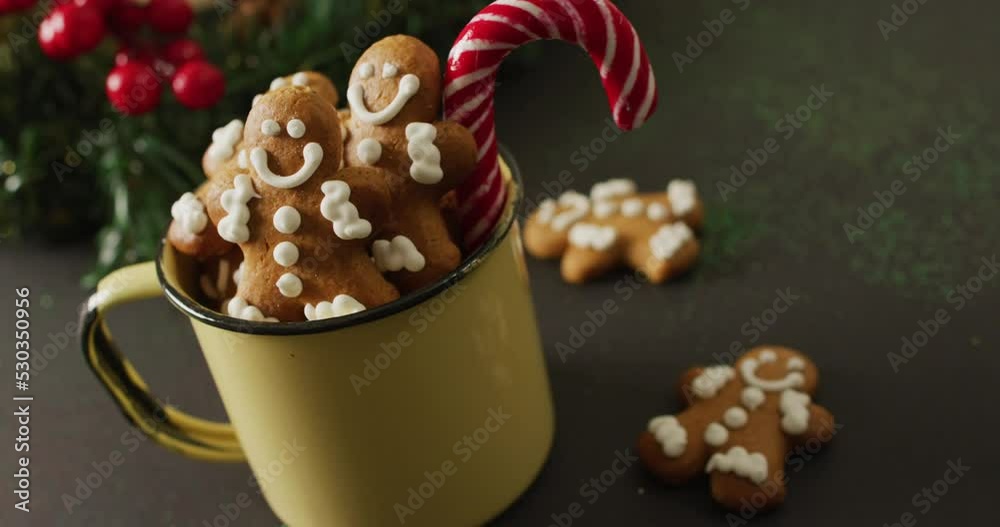 Video of cup with smiling gingerbread men over black background Stock ...