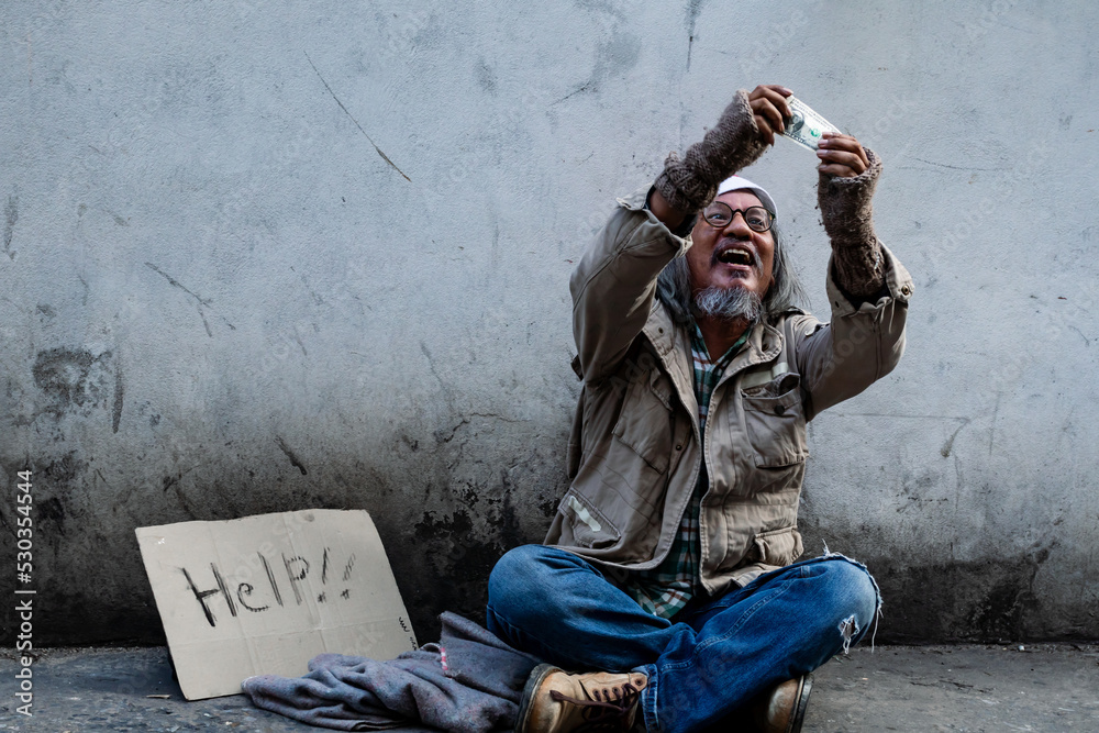Asian homeless man rejoices after receiving banknotes from passersby to ...