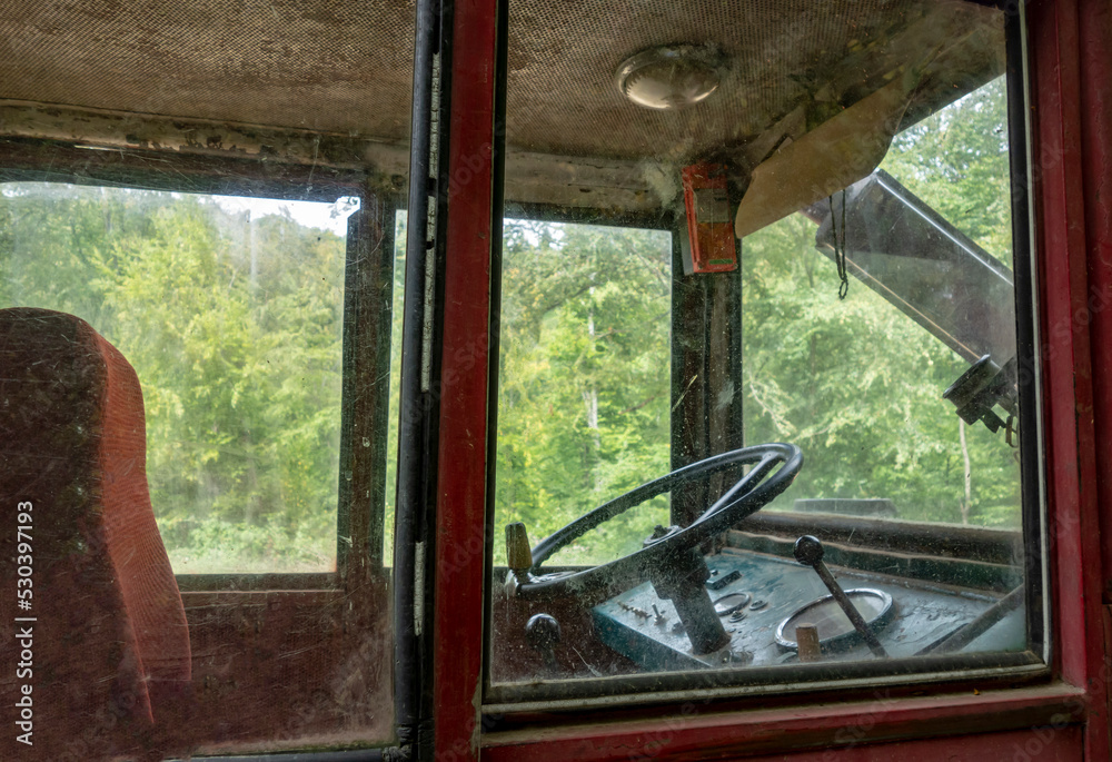 Cockpit of a forest tractor for harvesting wood deep in the forest ...