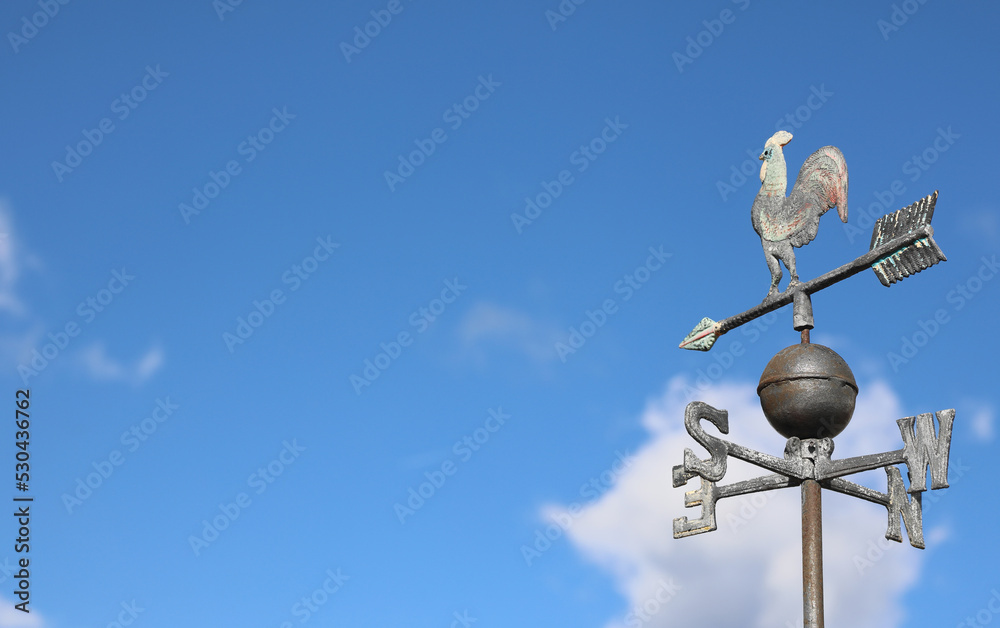weather vane in the shape of a rooster to indicate the direction of the ...