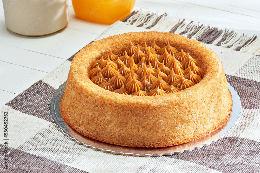Round churros cake with dulce de leche and cinnamon. Brazilian dessert ...