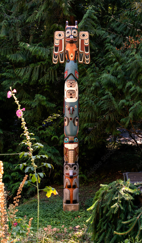 Native American totem pole in a forest Stock Photo | Adobe Stock