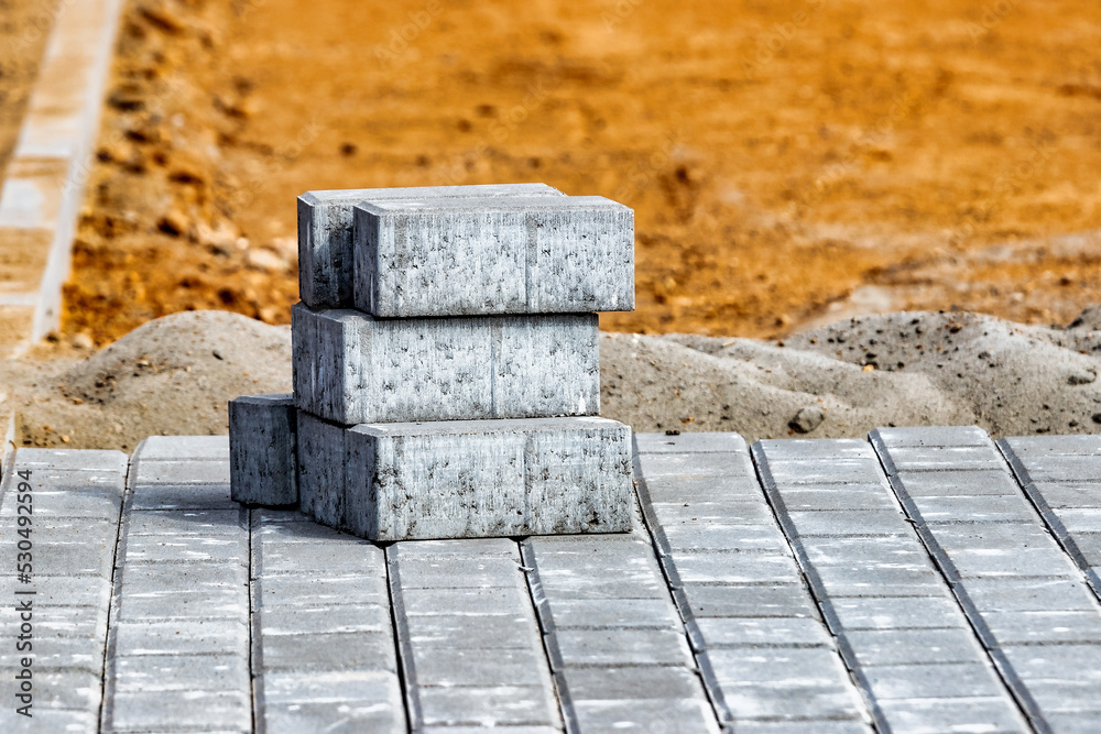 Pavement repairs and paving slabs laying on the prepared surface, with ...