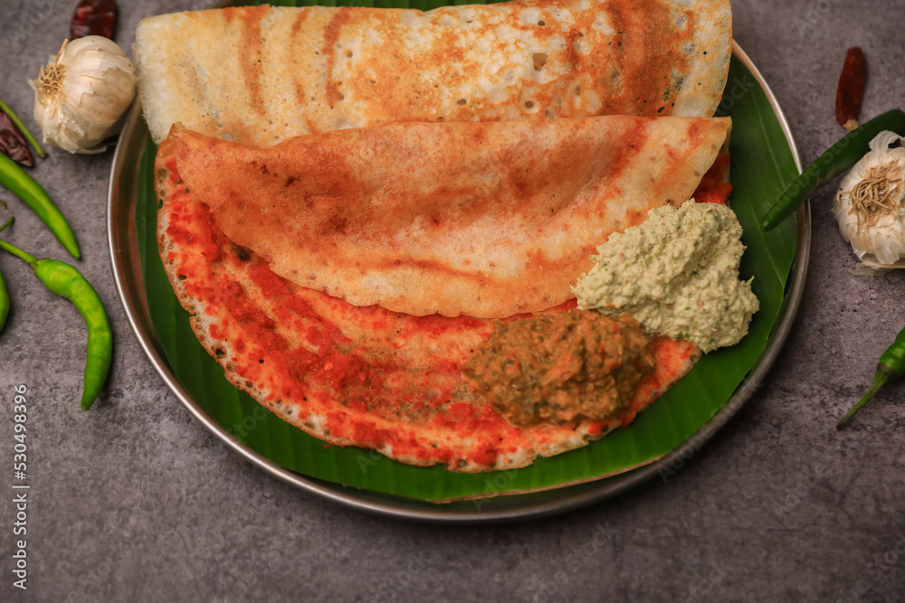 South indian famous break fast dosa with chutneys served in a banana ...