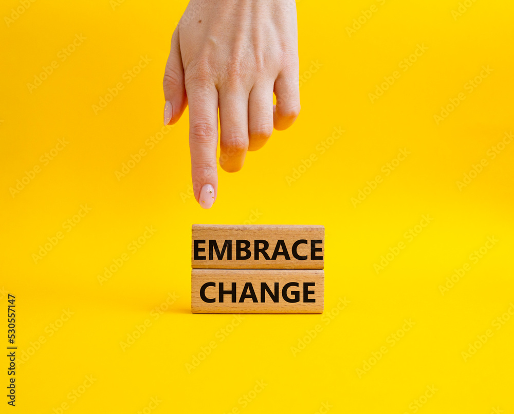 Embrace change symbol. Concept word Embrace change on wooden blocks. Beautiful yellow background ...