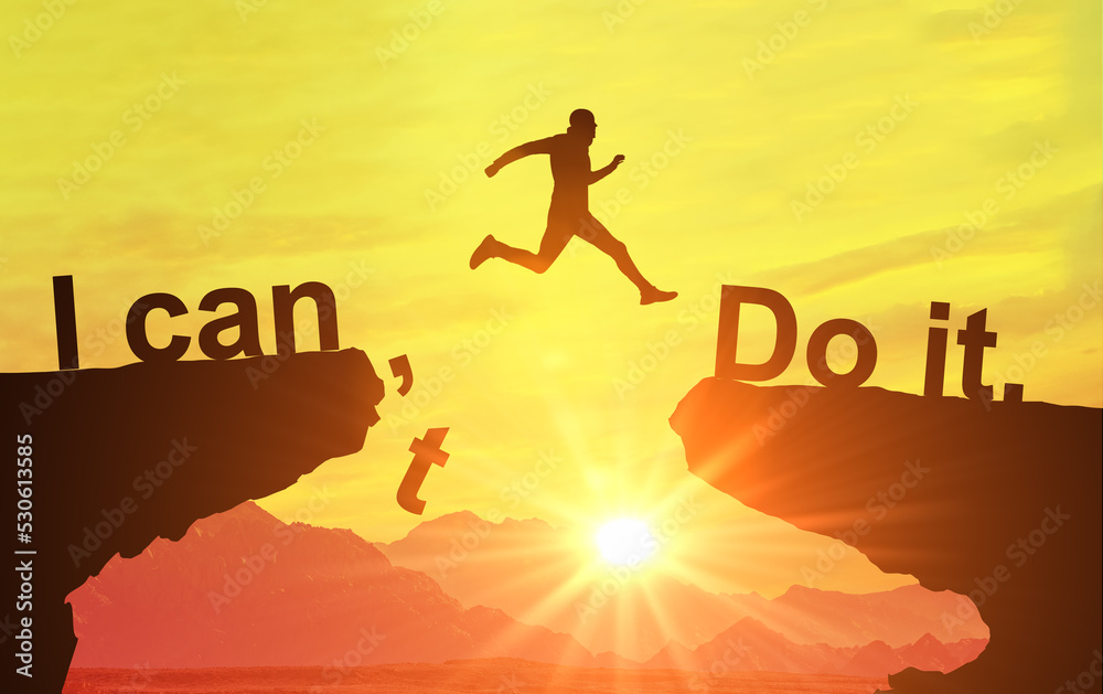 Silhouette of man jumping and change i can't do it to i can do it text on Mountain, sky and sun ...
