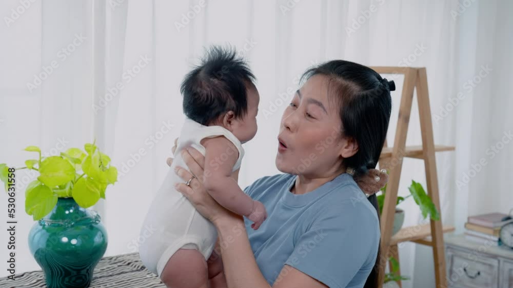 4K, Asian single mom, holding up his daughter, The mother held her ...