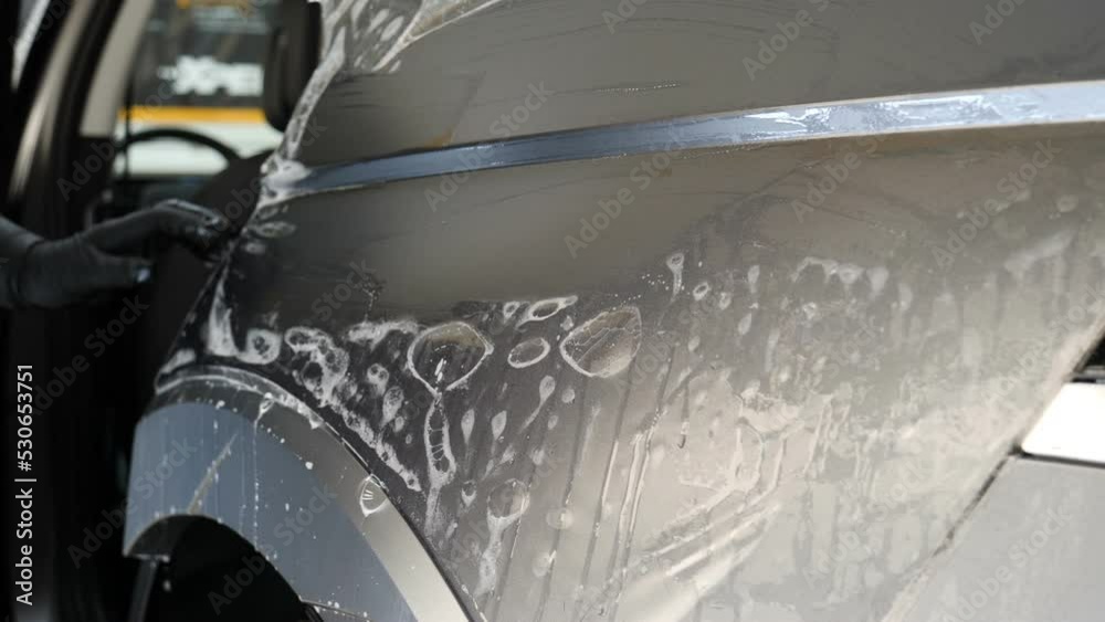 Close up to PPF installation process on a front headlight and hood. PPF ...