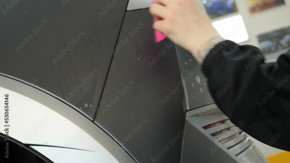 Close up to PPF installation process on a front headlight and hood. PPF ...