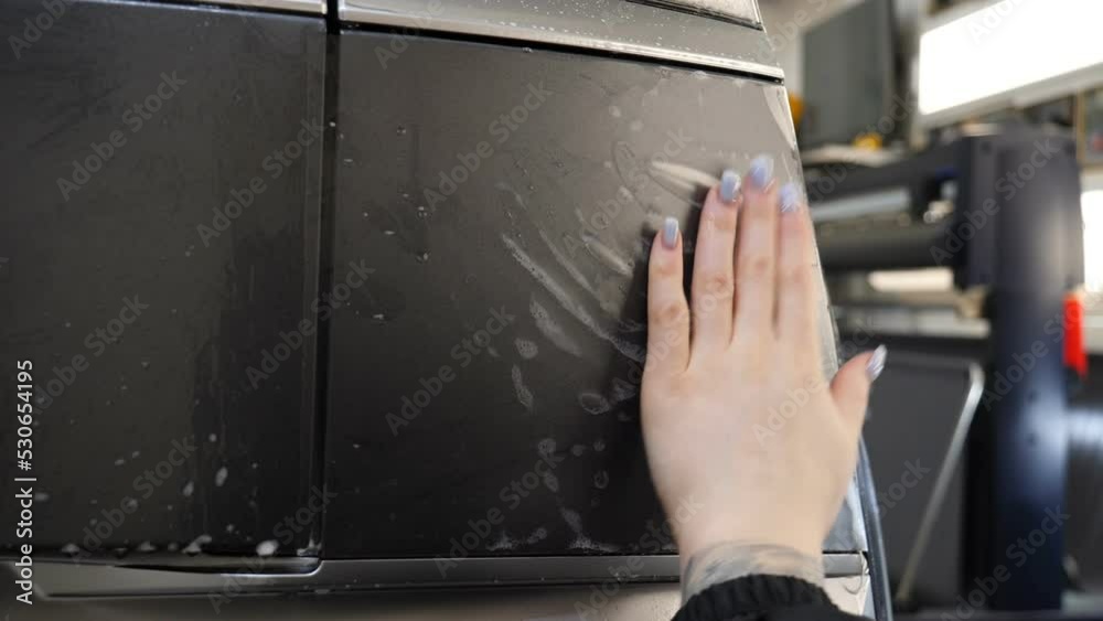 Close up to PPF installation process on a front headlight and hood. PPF ...