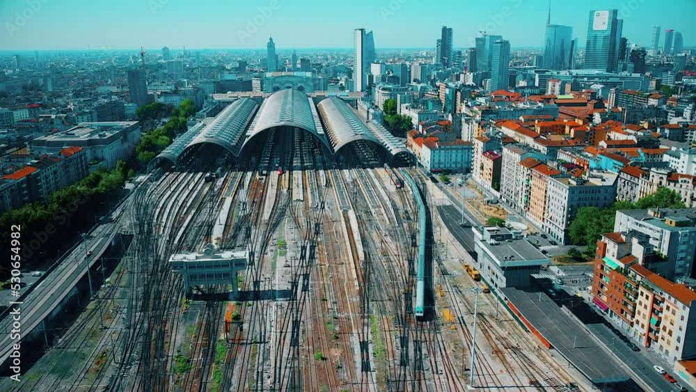 Aerial view of the station where trains arrive. An old arched structure ...