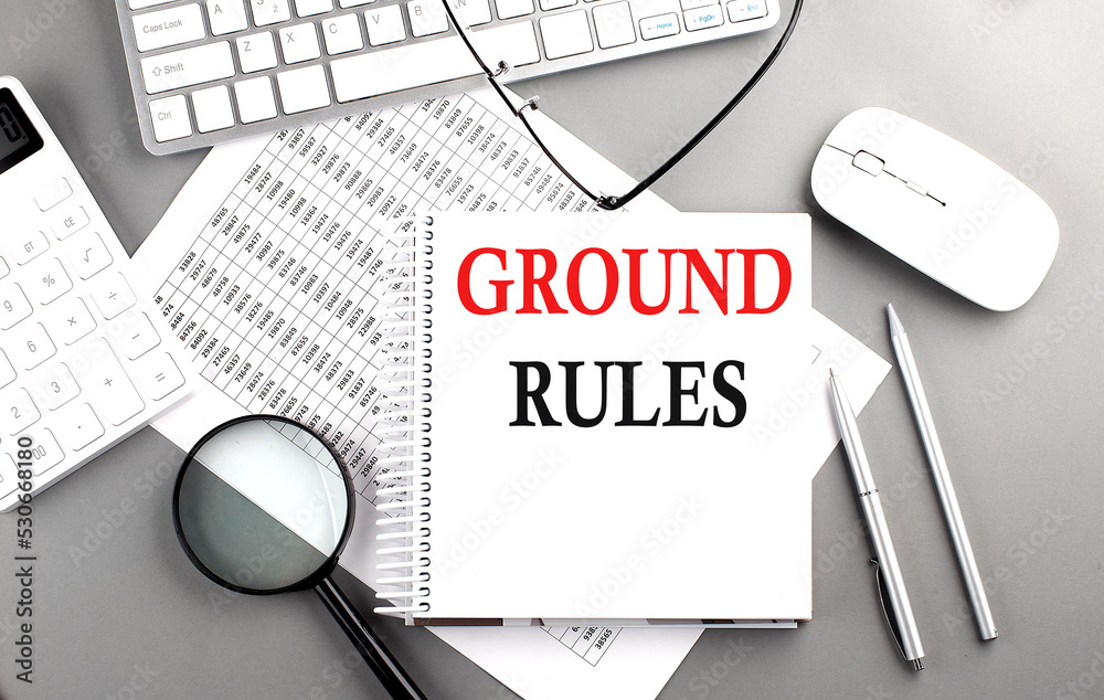 GROUND RULES text on notepad on chart with keyboard and calculator on ...