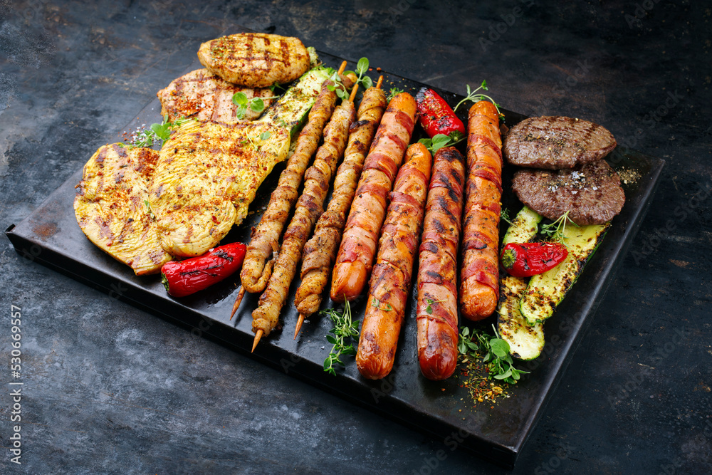 Traditional grill platter with bratwurst, hamburgers and steaks ...