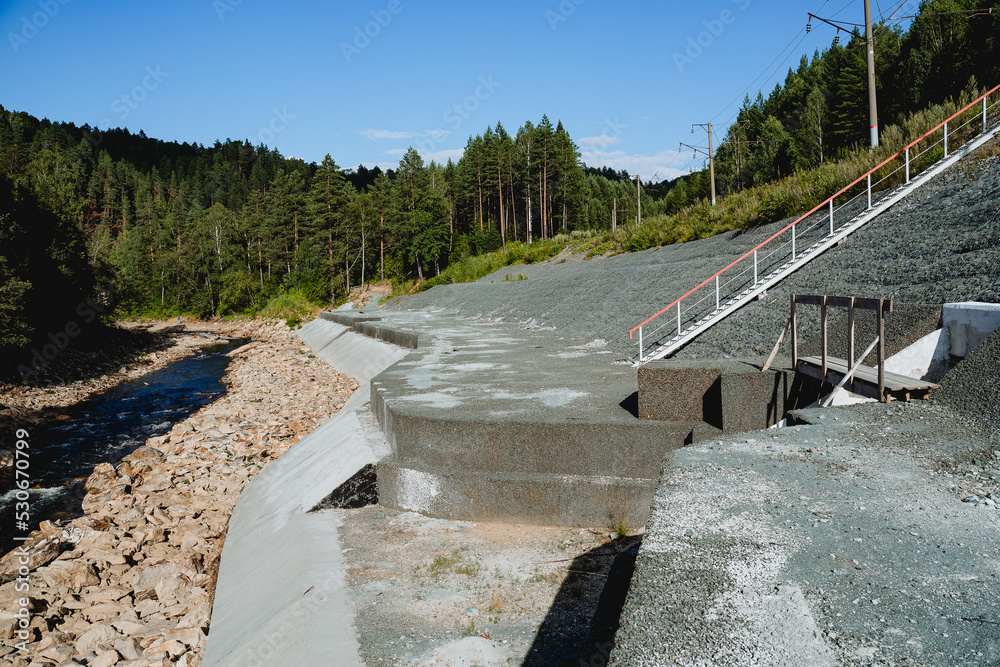 Strengthening the coastline of a mountain river, protecting the railway ...