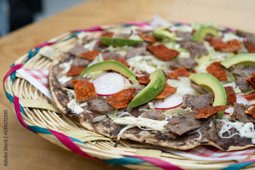 top view of Mexican food Tlayuda de cecina y chorizo and its ...