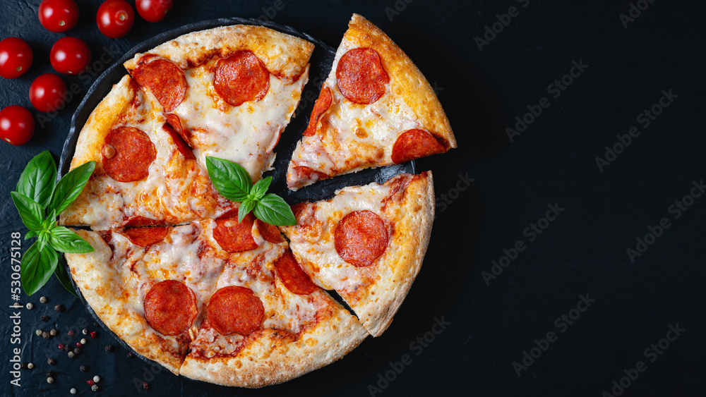 Hot pepperoni pizza and cooking ingredients tomatoes basil on black ...