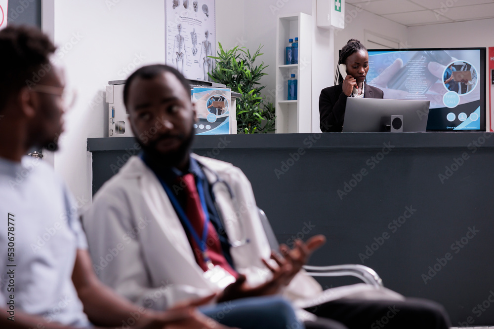 Hospital worker using landline phone call to make appointments with ...