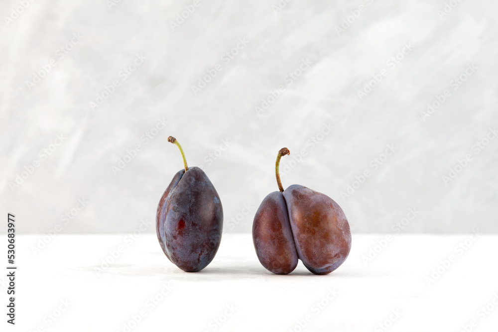 Two plums, normal and ugly fruit. Deformed Fused prune. Double fruit ...