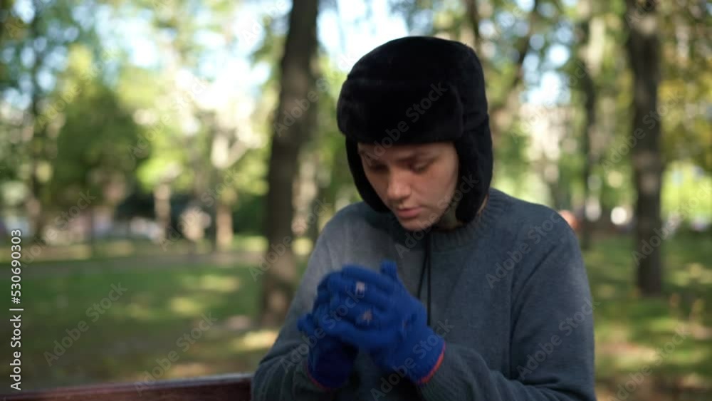 Excited homeless woman kissing food can sitting on bench in sunny park ...