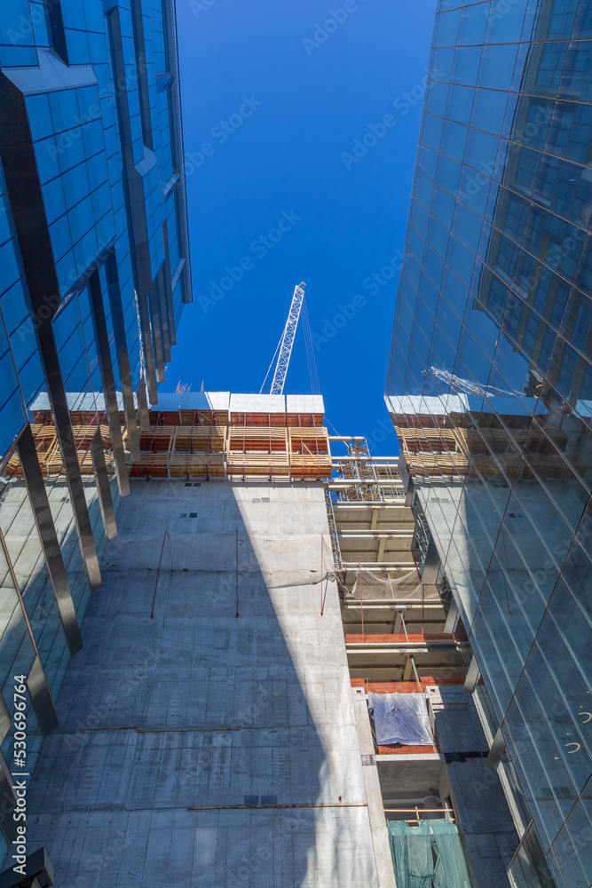 Construction of a high-rise building. Construction crane, scaffolding ...