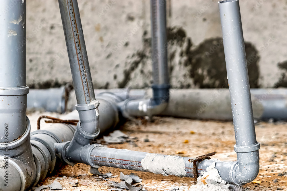 Sewer pipes in home basement. System of gray sanitary pipes when ...