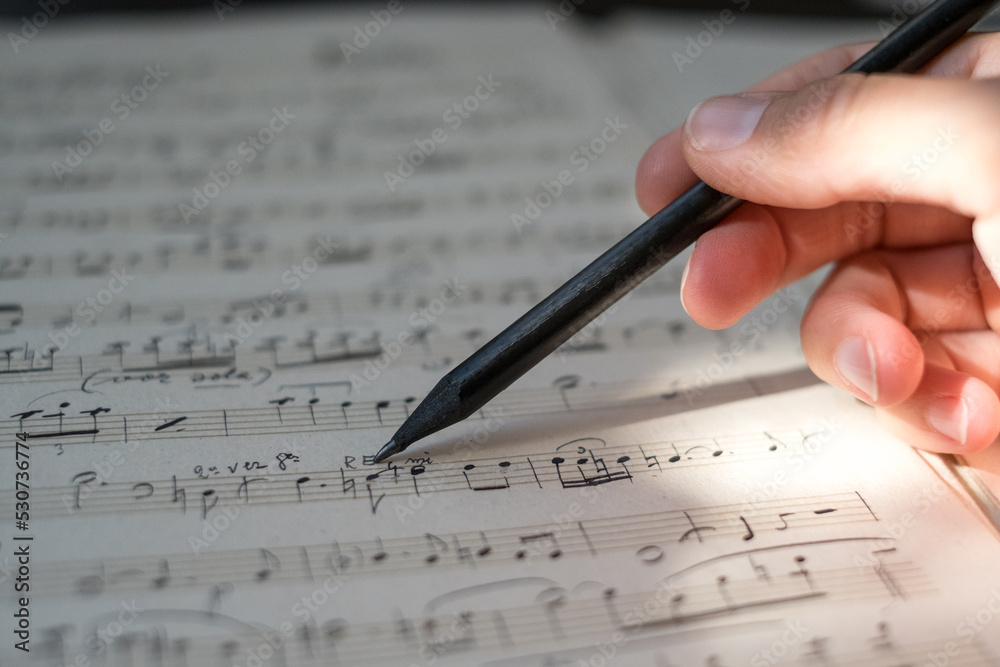 Zdjęcie Stock: Hands of a musician or composer writes a piece of music ...