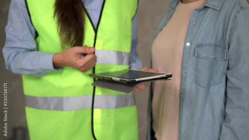 Woman And Female Architect Discussing Blueprint Of Living House At Construction Site Office Uses
