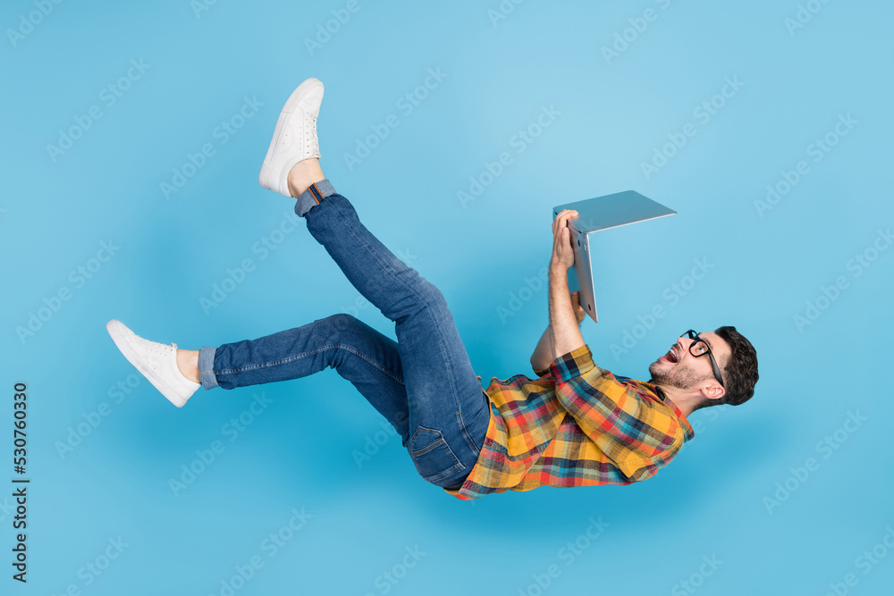 Full size profile photo of overjoyed handsome guy use netbook falling ...