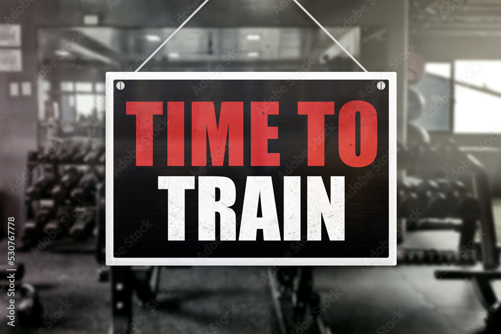 Time to Train Sign in front of a gym background. Motivation or encouragement concept. Hardcore ...