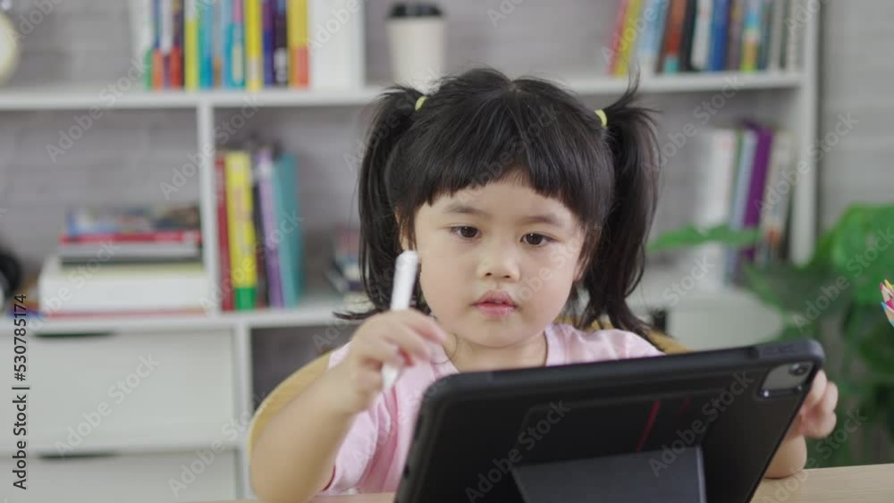 Asian girl using digital pen and touch on screen at the tablet screen ...