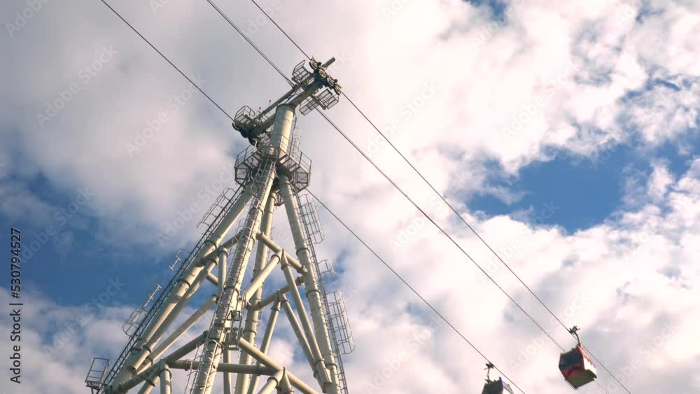 A cable car ride under the clouds. Blue sky, floating white clouds and ...