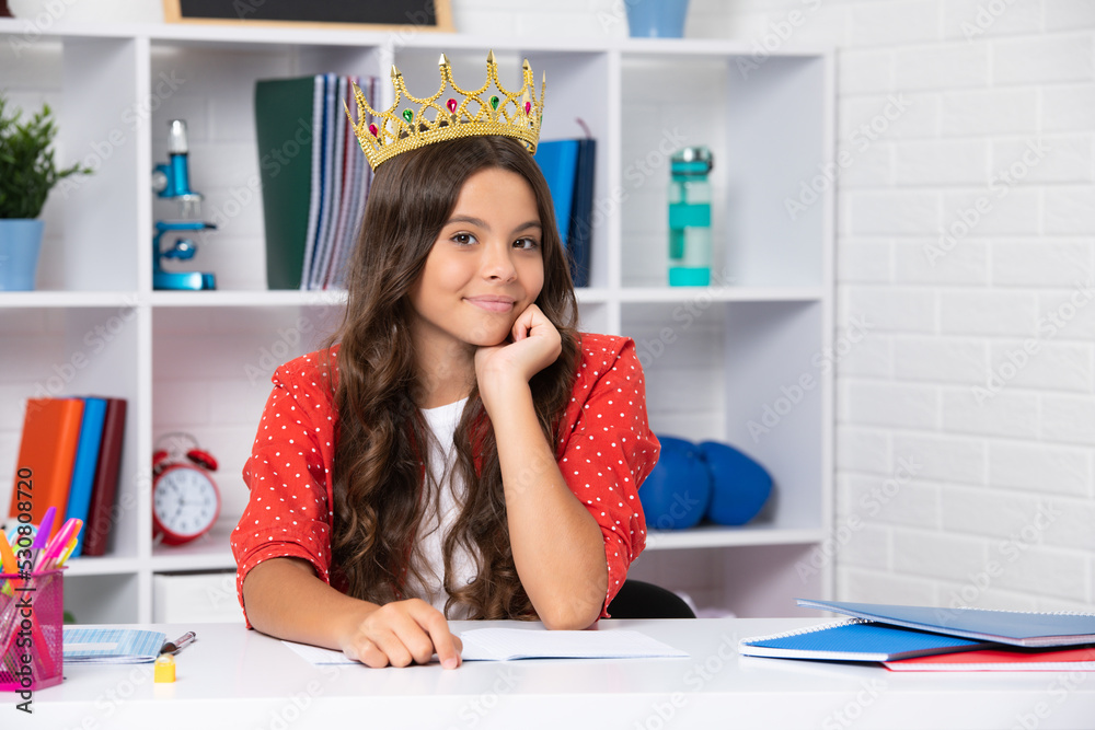 Little queen wearing golden crown. Teenage girl princess holding crown ...
