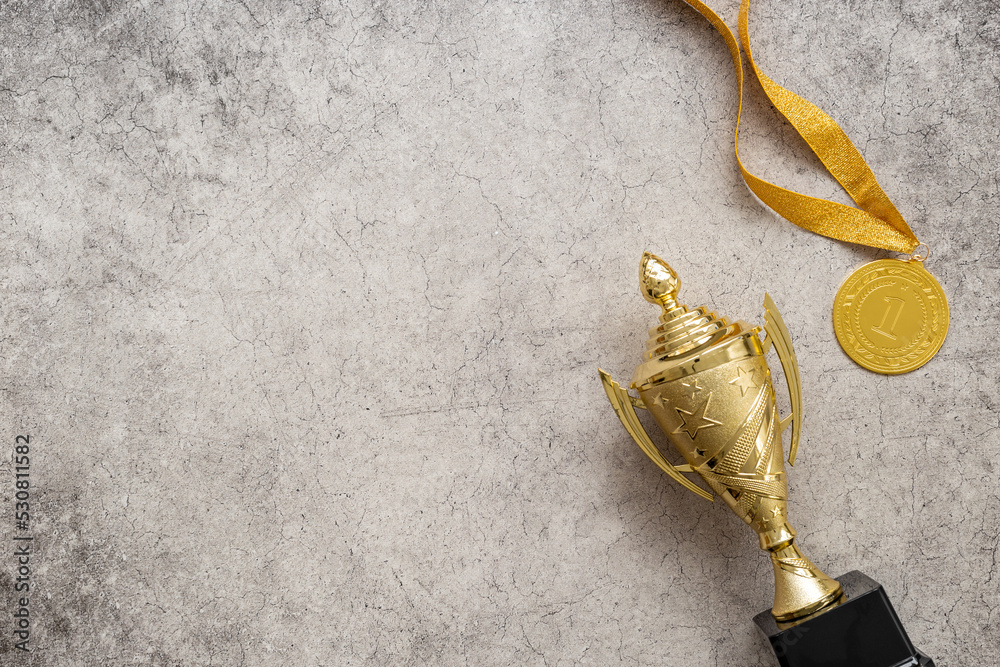 Winner and success background - gold medal and trophy cup, top view ...