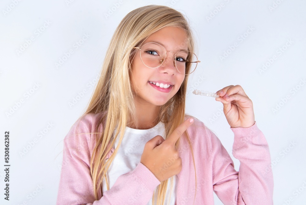 beautiful caucasian blonde little girl wearing pink jacket and glasses ...