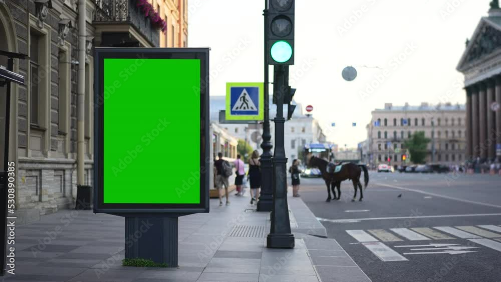 4k View of green mockup display, people and vehicles on city street ...